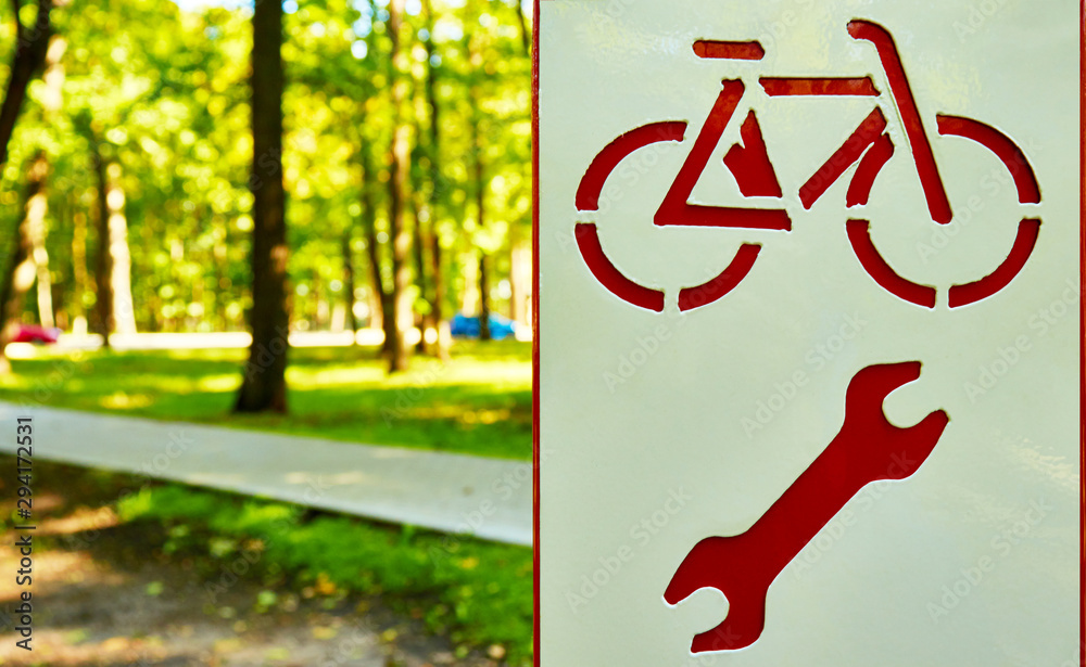Sign "Bike Repair Station" in the park. White plate with a picture of a ...
