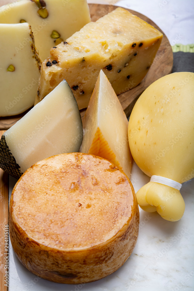 Variety of Italian pecorino and provolone cheeses, yellow aged, with ...