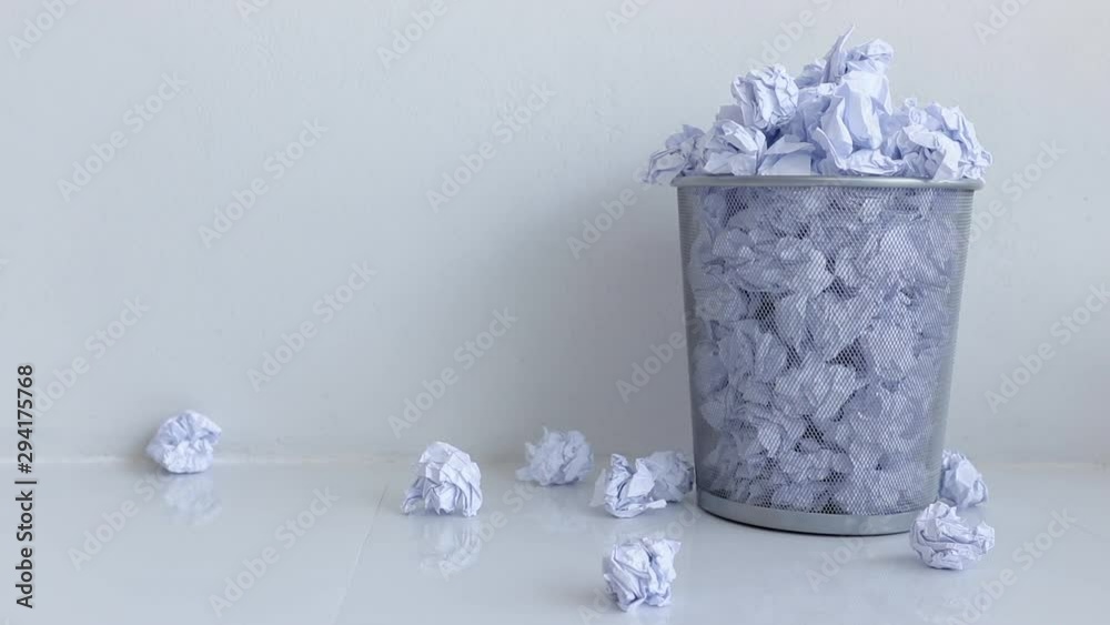 Crumpled paper throw into the gray trash with sliding view. Tossing ...