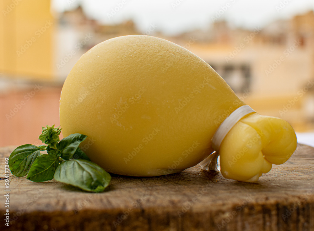 Italian provolone caciocavallo aged cheese in teardrop form with yellow ...