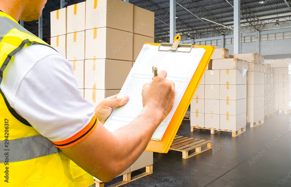 warehouse worker hand holding clipboard inspecting checklist of goods ...