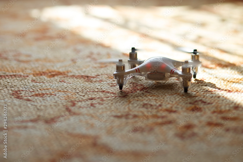 Small white drone with white, black rotating blades, red marker lights ...