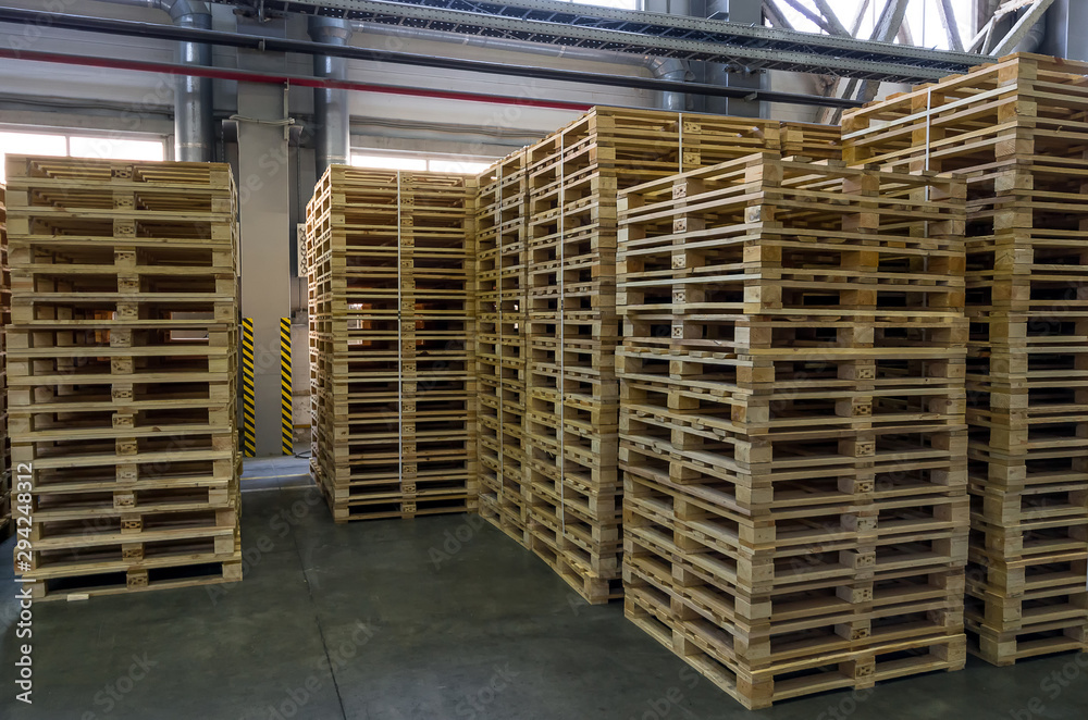 empty wooden pallets in the warehouse. Stock Photo | Adobe Stock