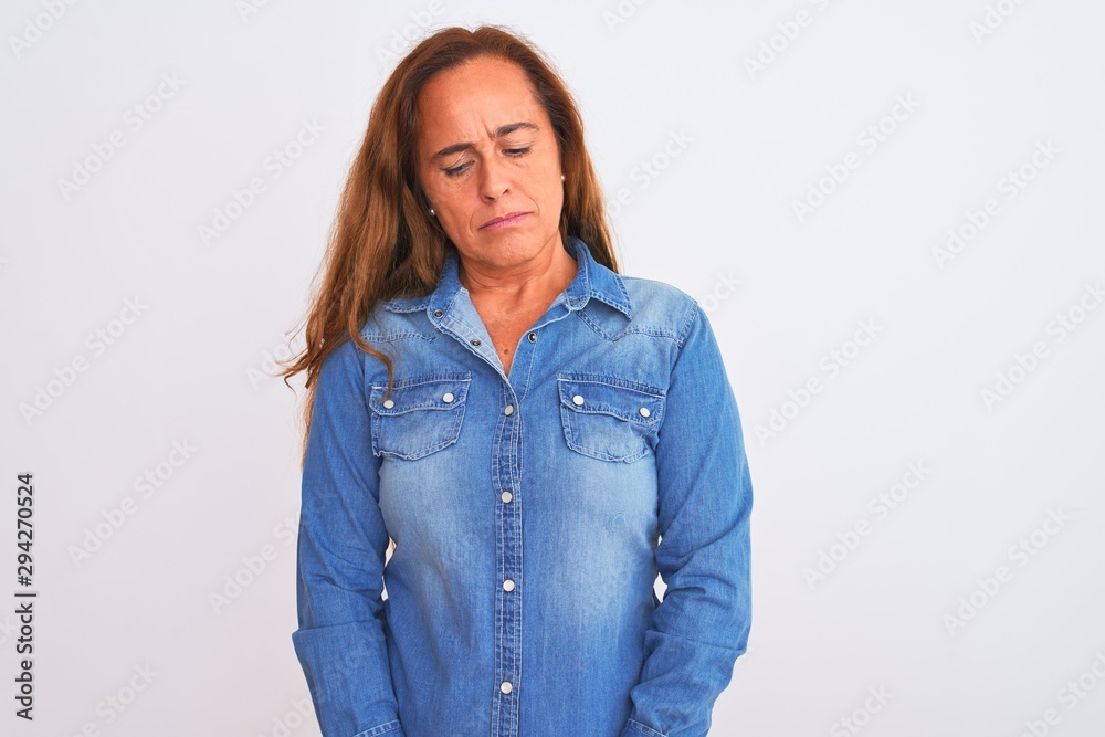 Middle age mature woman wearing denim jacket standing over white ...
