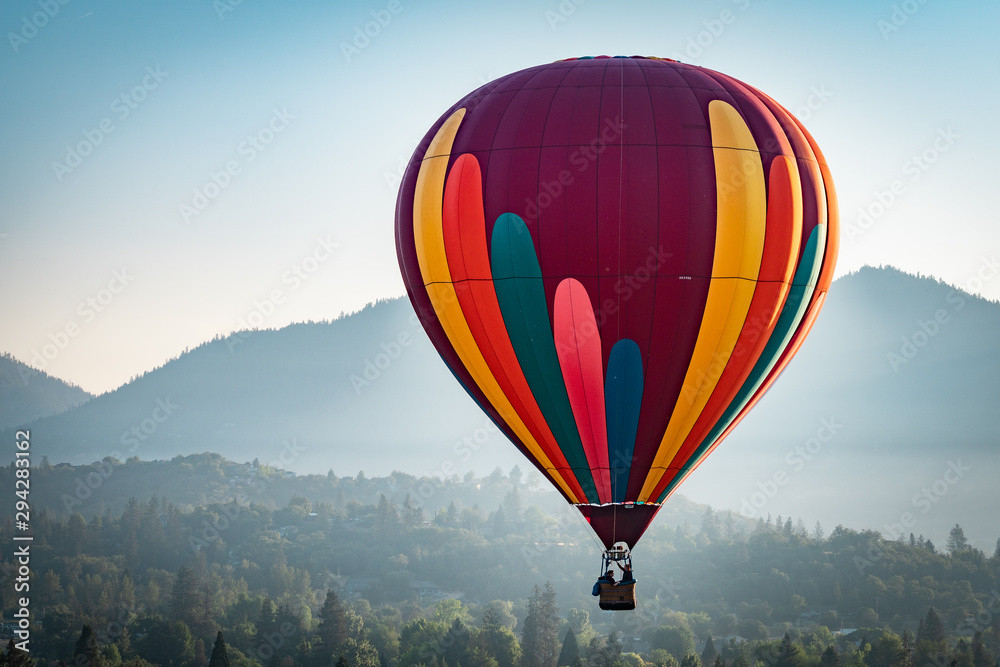Colorful hot air balloon over Grants Pass Oregon on a beautiful summer ...