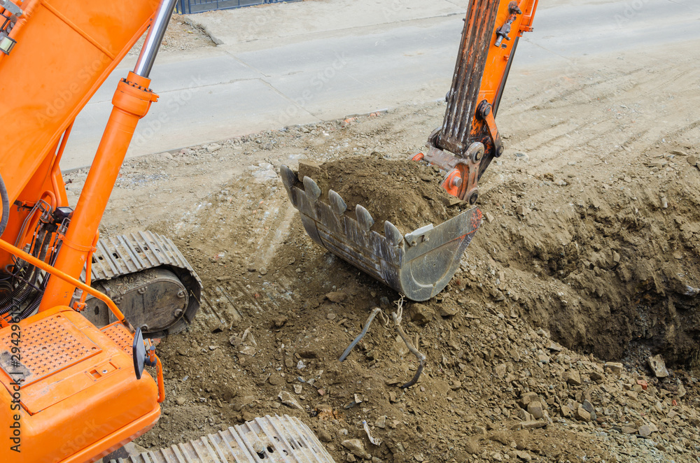 xcavator digging a ditch on the construction site. Stock Photo | Adobe ...