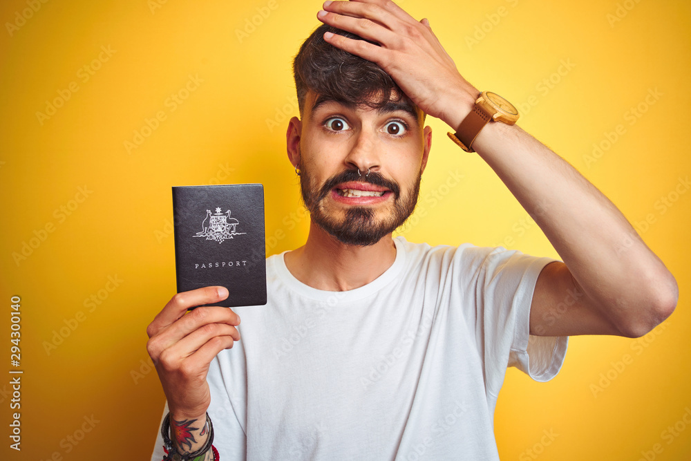 Young man with tattoo wearing Australia Australian passport over ...