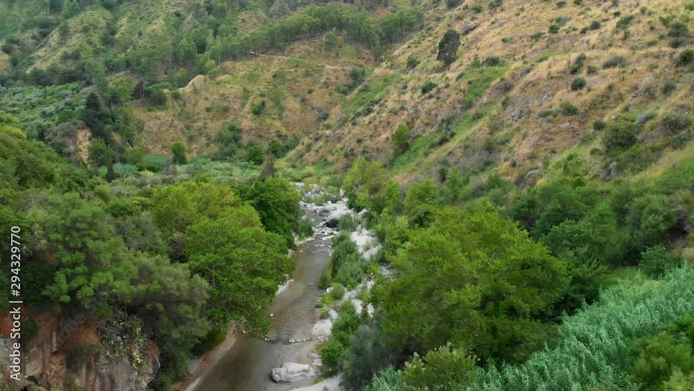 Stockvideo 4K AERIAL DOLLY OUT: Drone flying above Alcantara Gorges, an ...