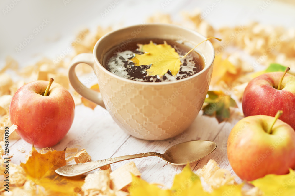 Cup with tea. Autumn background with yellow maple leaves and apples ...