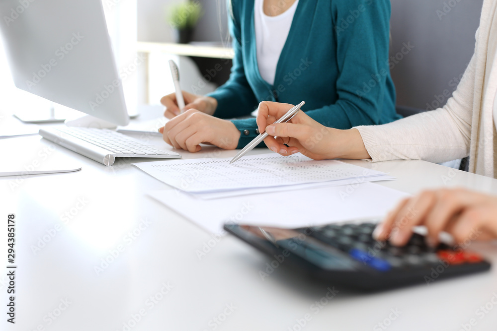 Accountant checking financial statement or counting by calculator ...