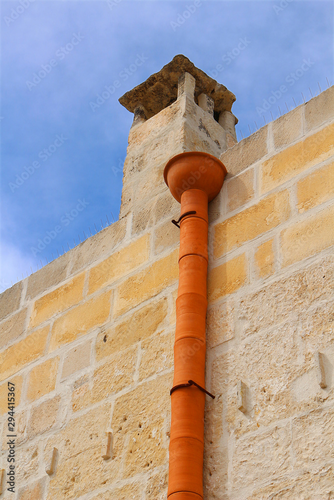 Old style rainwater downpipe restored on medieval house wall Stock ...