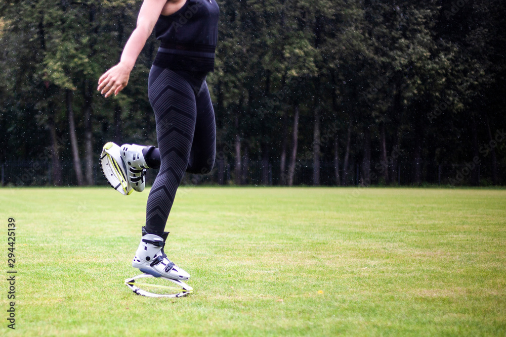 Girls in boots for jumping. Bouncing shoes on the legs of women. Sports ...