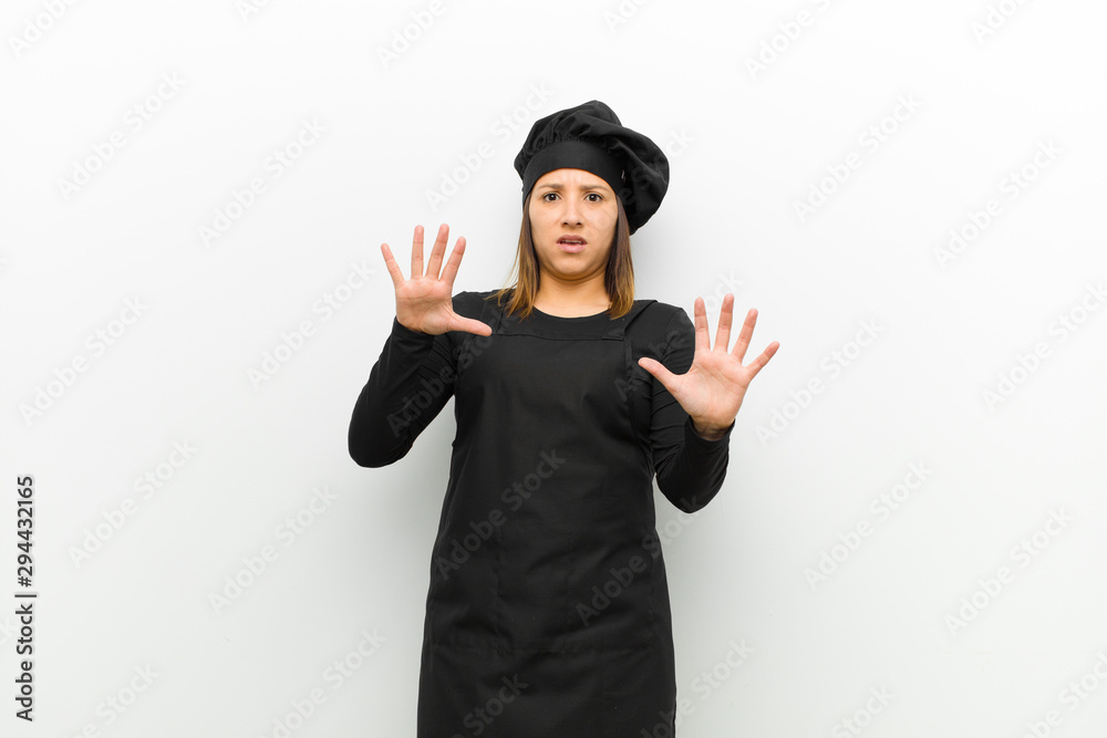 cook woman feeling terrified, backing off and screaming in horror and ...