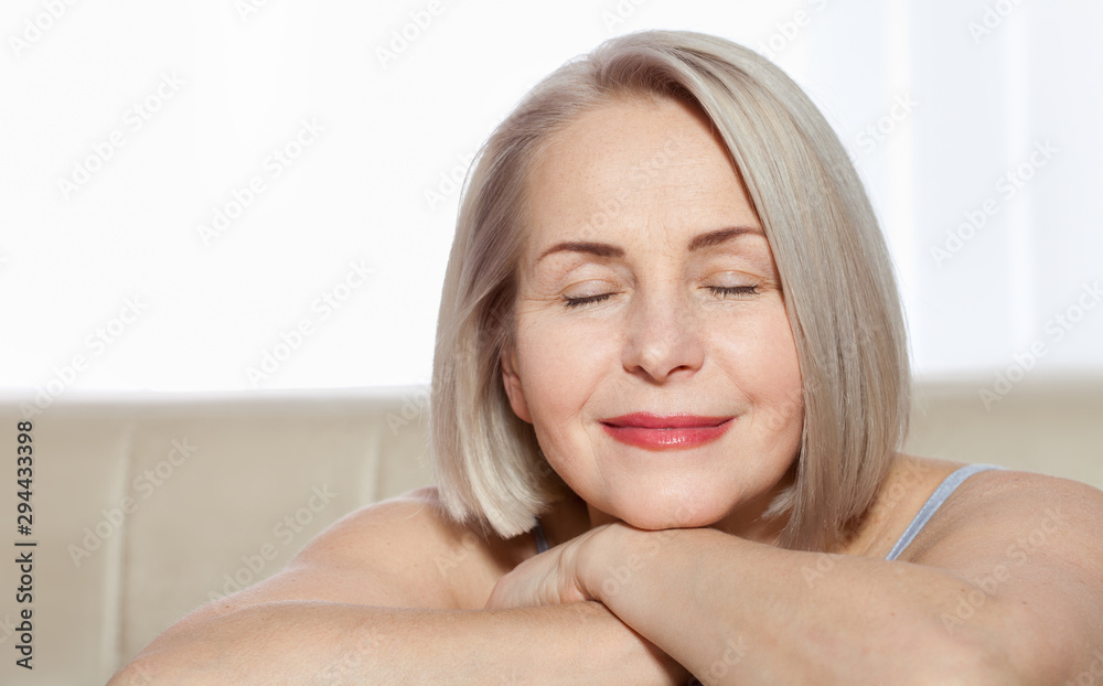 Beautiful middle-aged blonde woman shows off her perfectly well-groomed ...