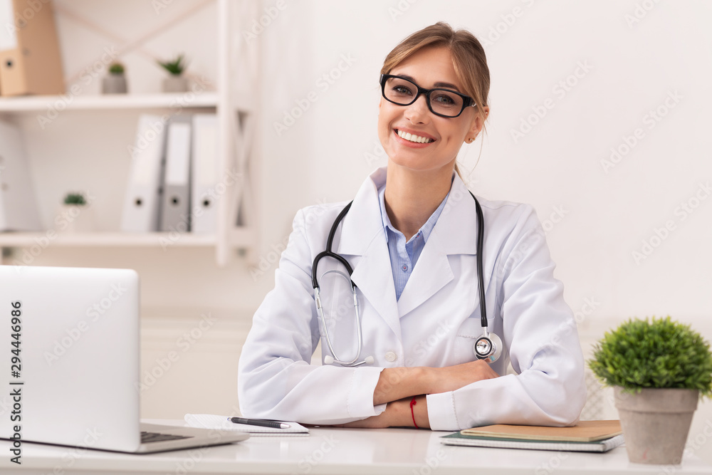 Lady Doctor Smiling At Camera Sitting In Modern Clinic Office Stock ...