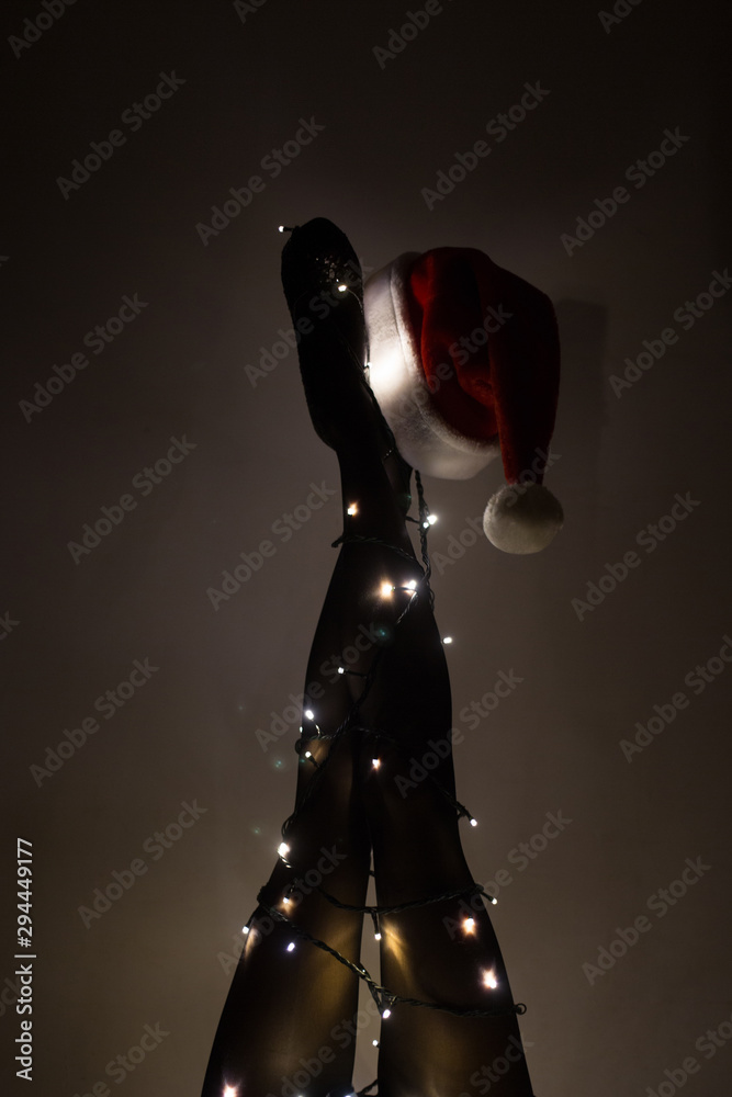 Sexy Santa Claus legs as a Christmas tree. Beautiful woman legs wearing ...