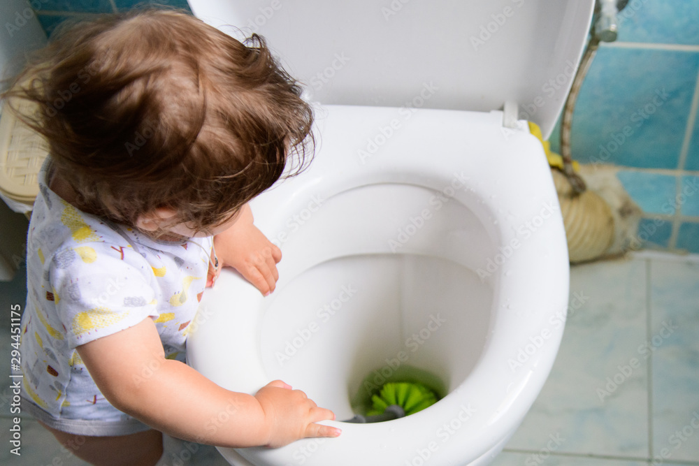 the child cleans the toilet. Child labour. Little girl cleans the ...