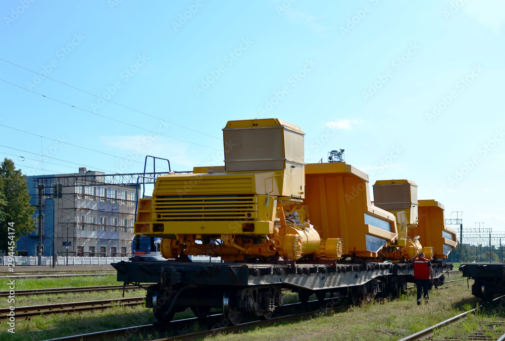 Logistics transportation heavy mining dump truck by rail. Yellow mining ...