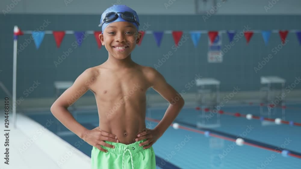 Portrait Of Boy Standing By Edge Of Swimming Pool Ready For Lesson ...