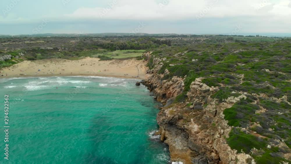 Vidéo Stock AERIAL DOLLY IN: Drone flying over Calamosche beach, in the ...