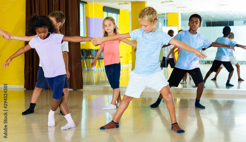 boys and girls dancing rock-and-roll in pairs with female trainer Stock ...