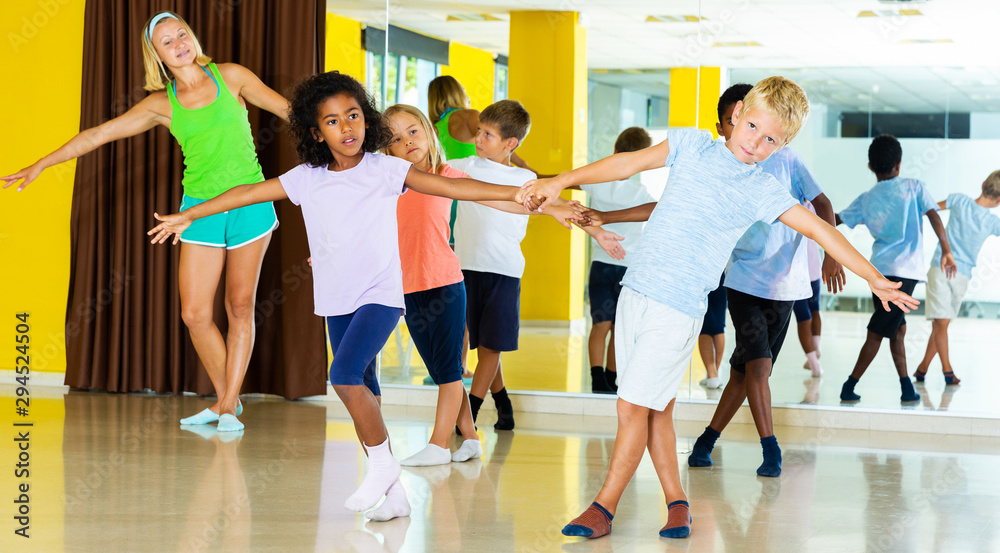 boys and girls dancing rock-and-roll in pairs with female trainer Stock ...