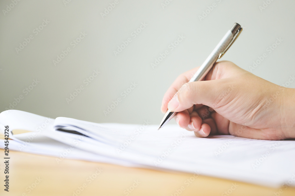 Hand of man signing signature filling in application form document ...