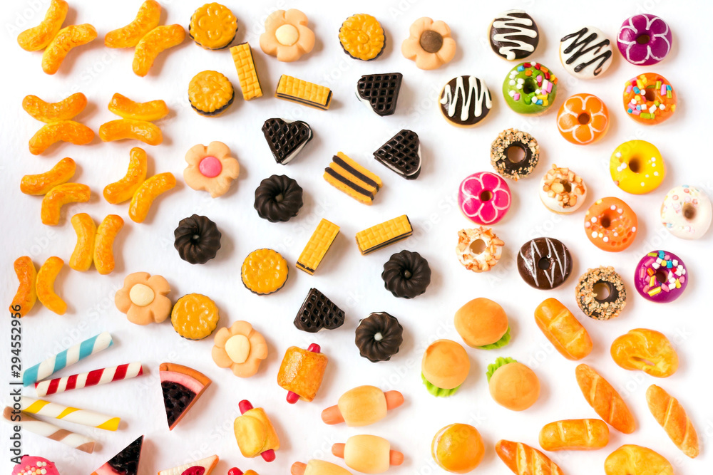 Variety of miniature clay bakery and pastry isolated on white ...