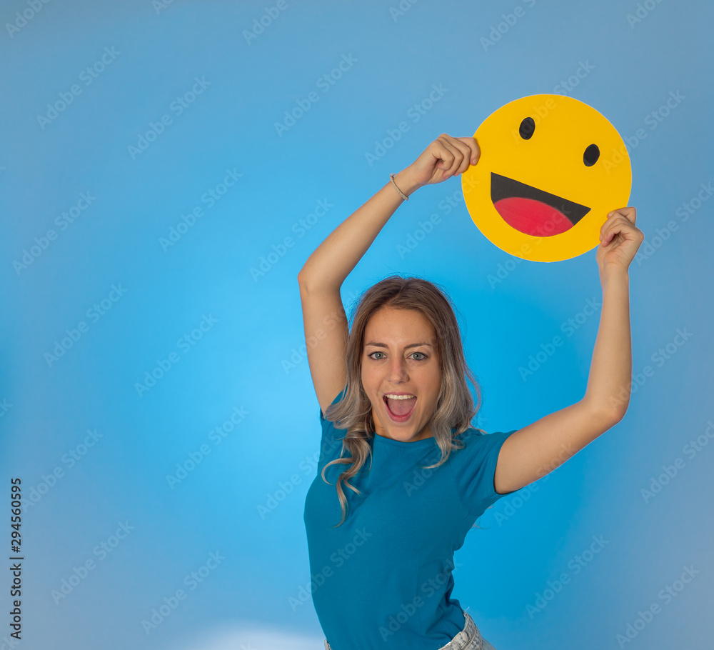 Beautiful young woman holding happy face emoji emoticon social media ...
