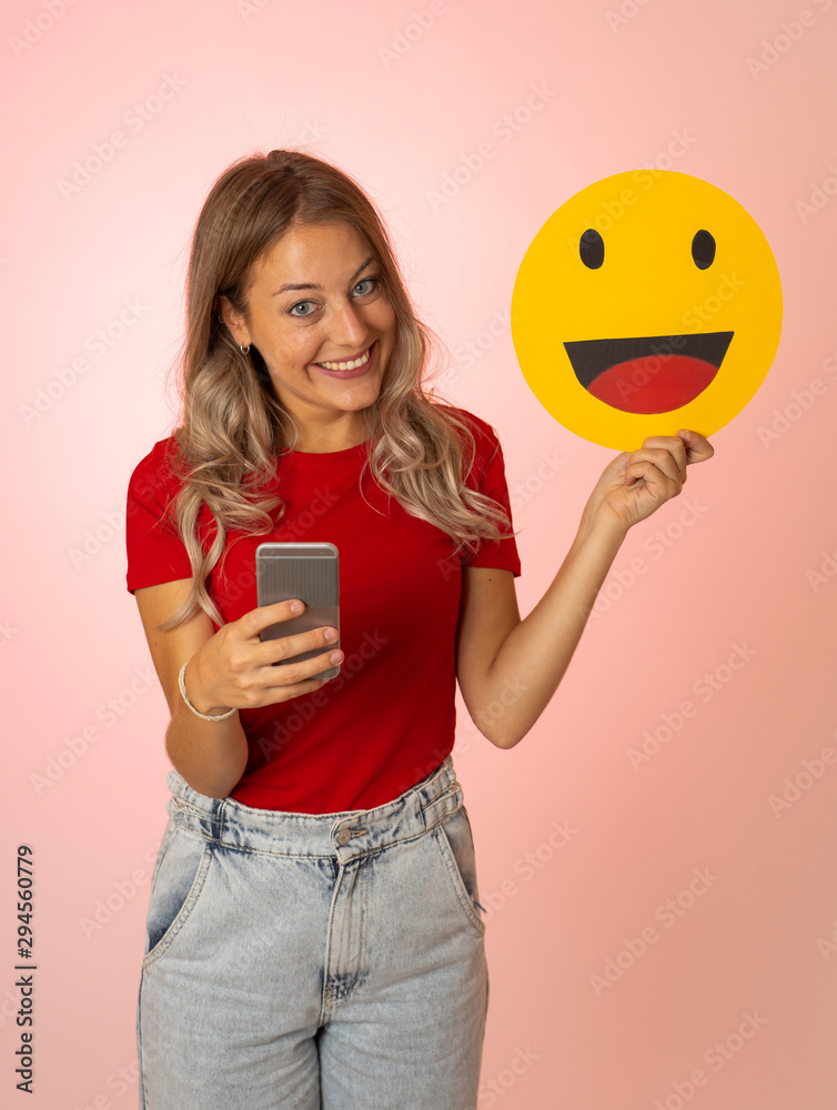 Beautiful young woman holding happy face emoji emoticon social media ...