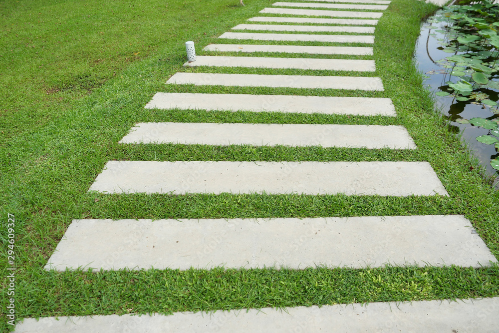 Curved sidewalk on the green lawn, Rectangle concrete slabs were laid ...
