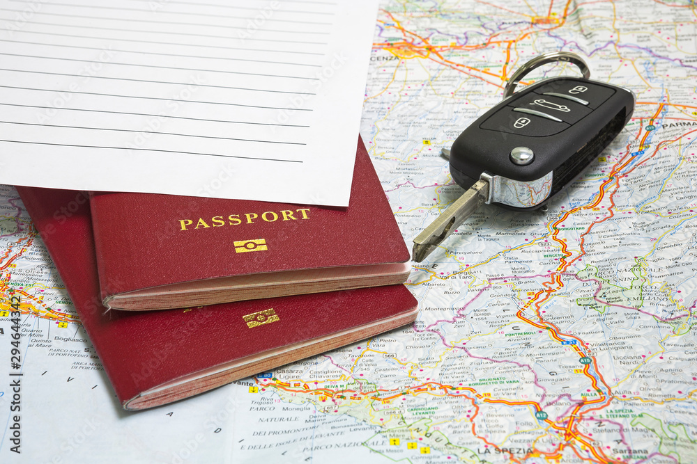 Russian passports, car keys and list of notebook on a map of Europe ...