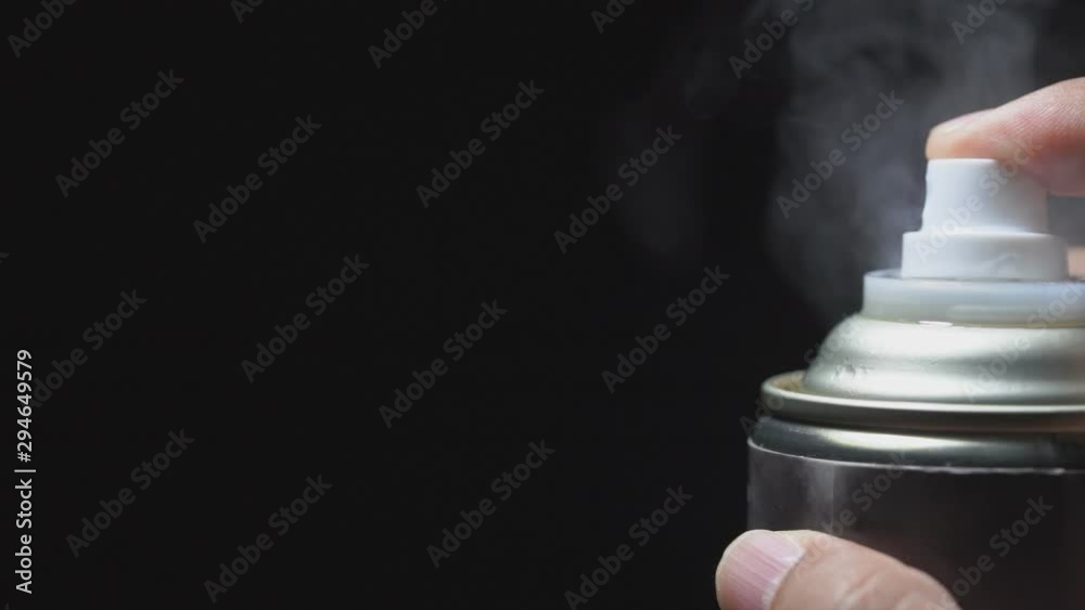 Slow-motion scene of human finger pressing spray nozzle to spray ...