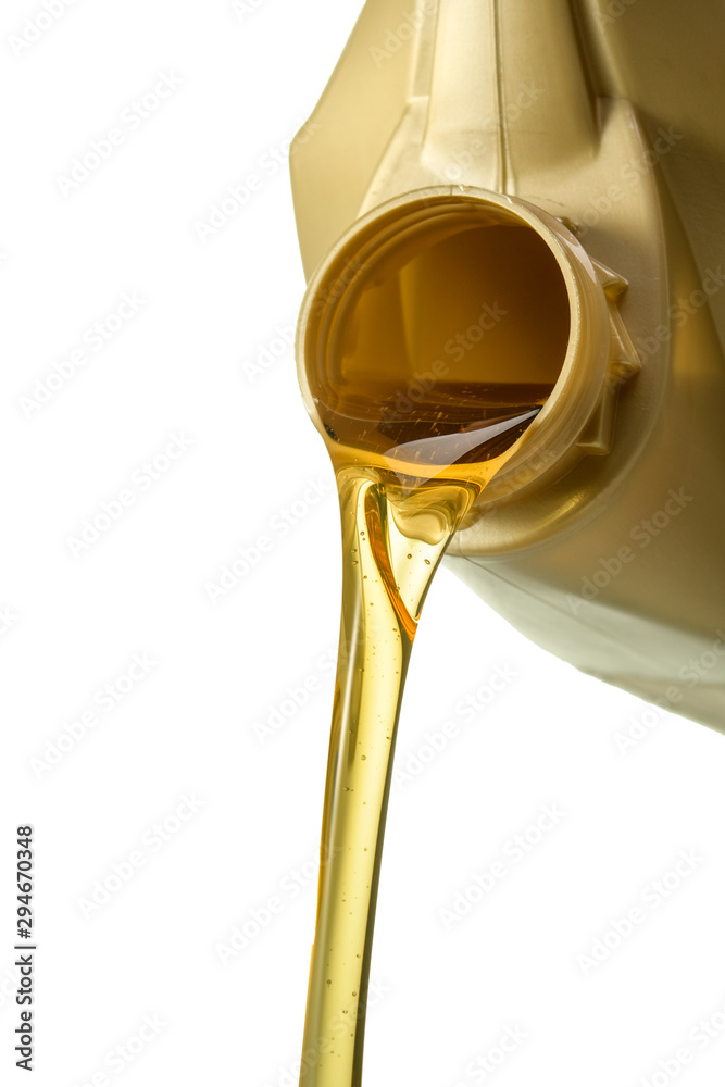 Filling engine oil from a golden canister. Canister with a splash of ...
