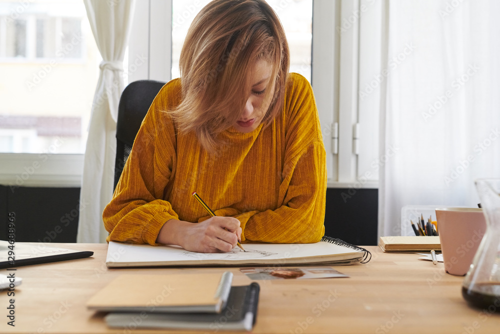 Young woman drawing with inspiration Stock Photo | Adobe Stock