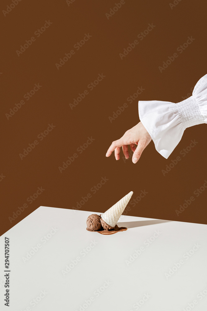 Ice cream cone falling from woman's hand Stock Photo | Adobe Stock