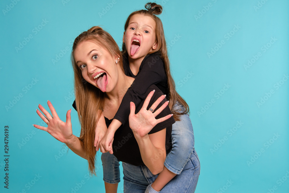 Mom and daughter with a funny hairstyles, dressed in black shirts and ...