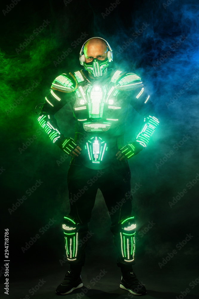 Mysterious man in black wear, neon mask and gloves. Character pastor or ...