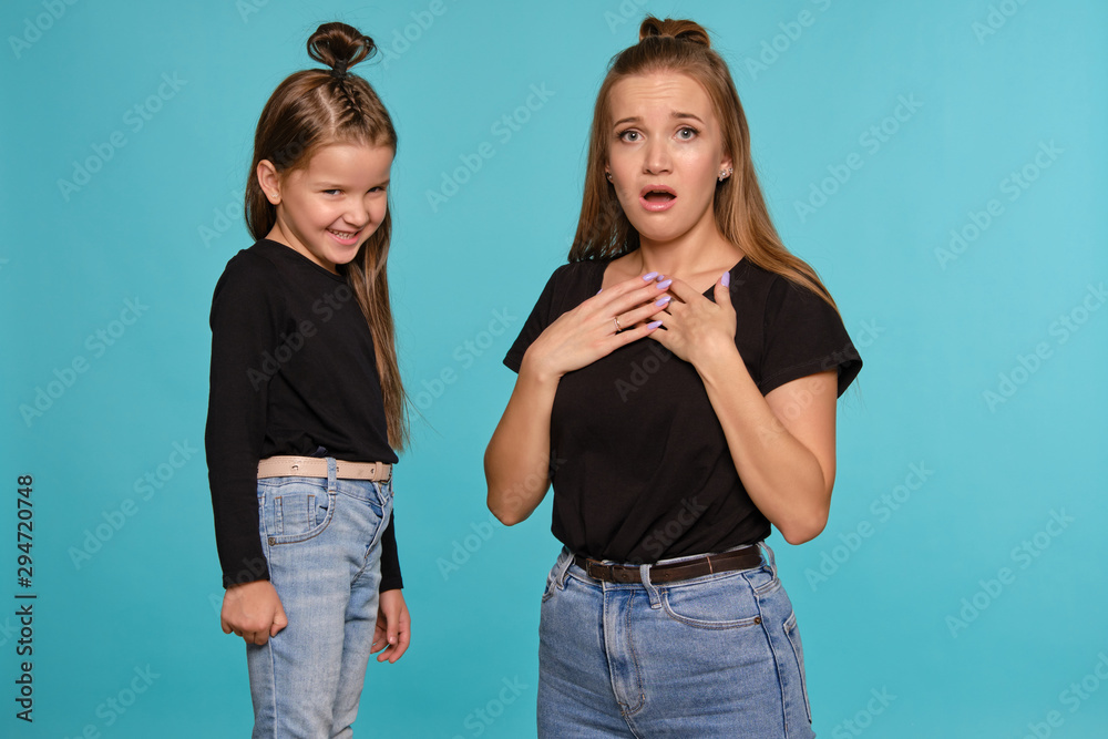Mom and daughter with a funny hairstyles, dressed in black shirts and ...