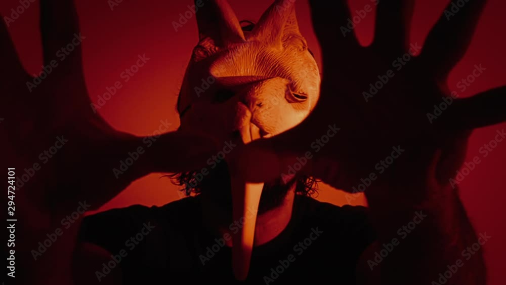 Blood red lighting: an evil man (a crazy psycho killer), wearing a ...