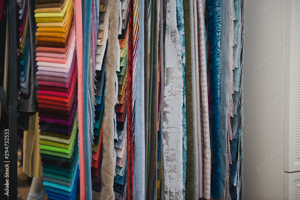 Many fabrics of different types. Colorful fabric swatches on shopfront ...