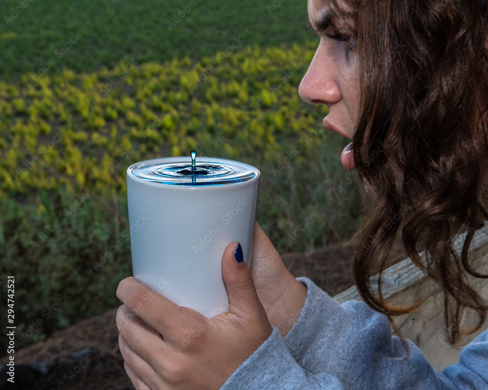 Water drop column elicits a surprised expression from the female teen ...
