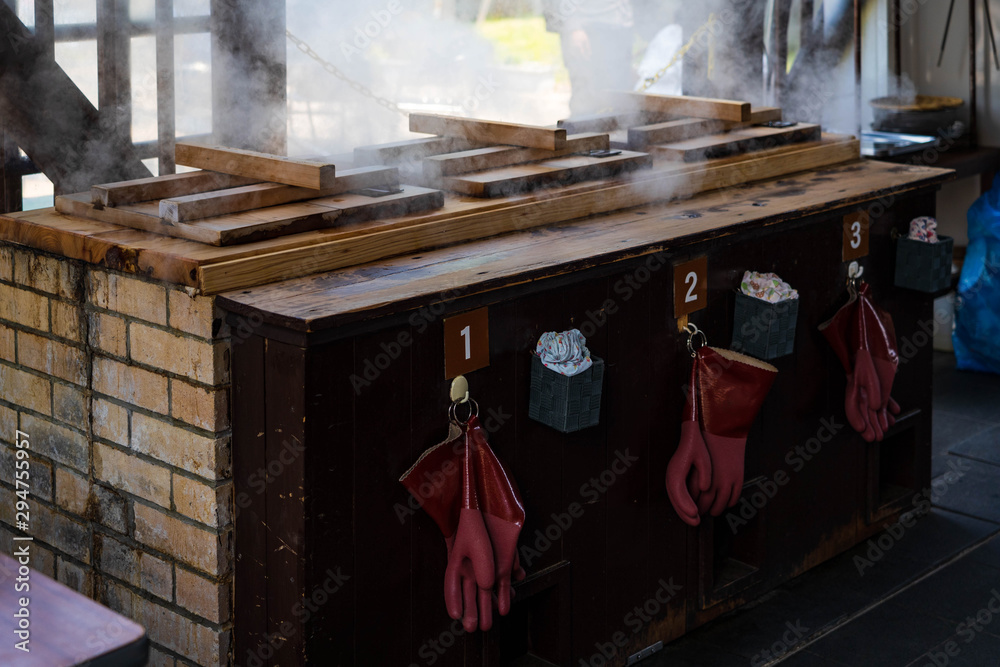 Traditional Japanese wooden Hot steam cooking, hot spring energy ...