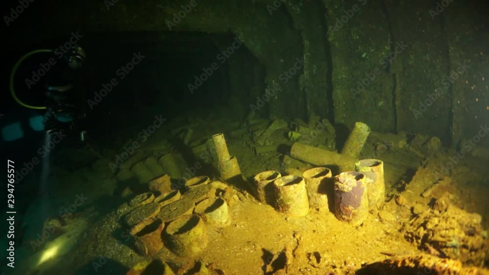 Diver inside hull of sunken ship underwater of Pacific Ocean on Chuuk ...