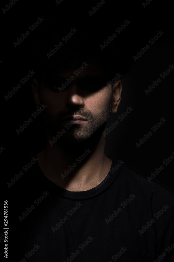 shadow portrait of a young man dark background Stock Photo | Adobe Stock