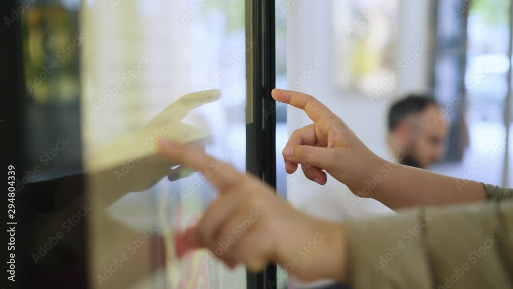 Woman using touchscreen terminal in mall. Detail view outstretched ...