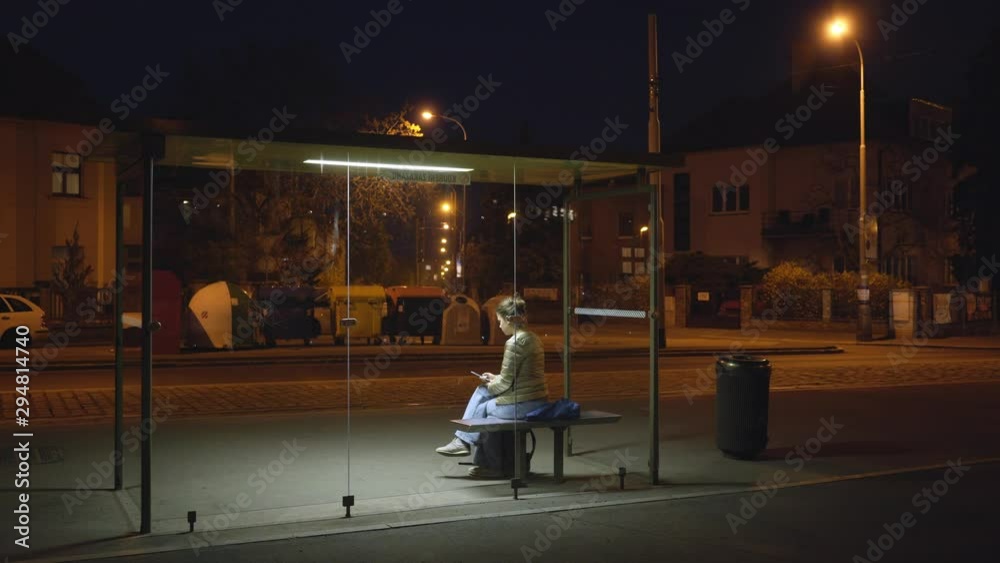 Illuminated bus stop in residential area on the outskirts of the city ...