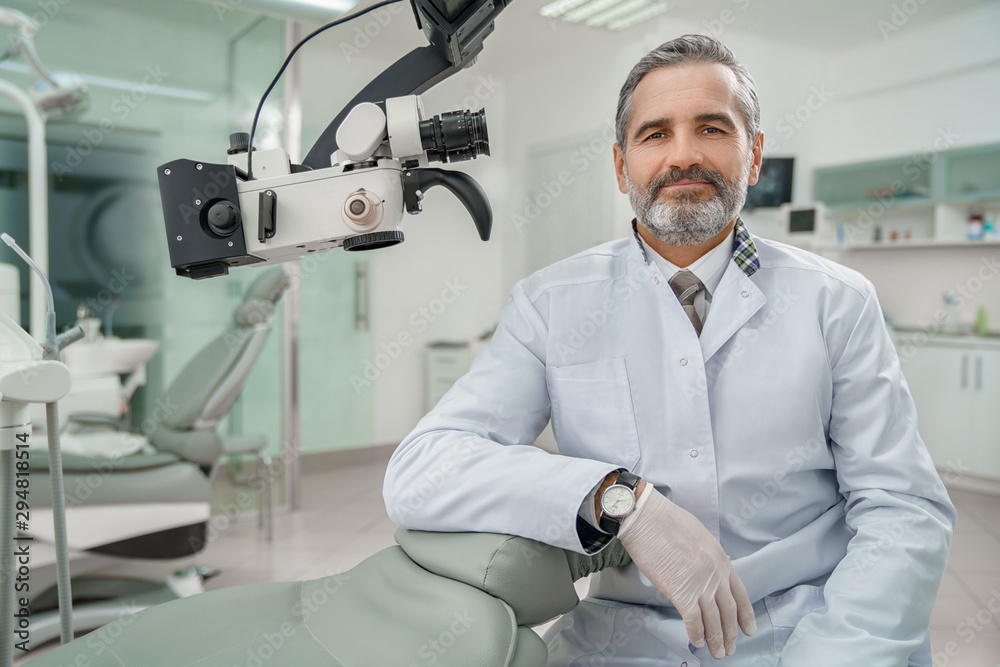 Professional male dentist looking at camera and smiling Stock Photo ...