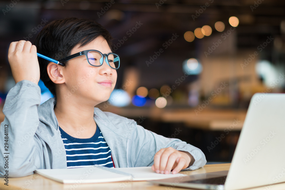 Smart looking Asian preteen boy with eye blue light blocking glasses ...