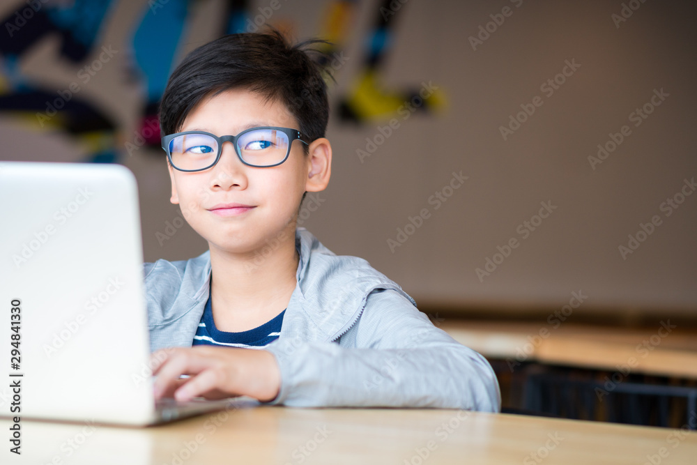 Smart looking Asian preteen boy with eye blue light blocking glasses ...